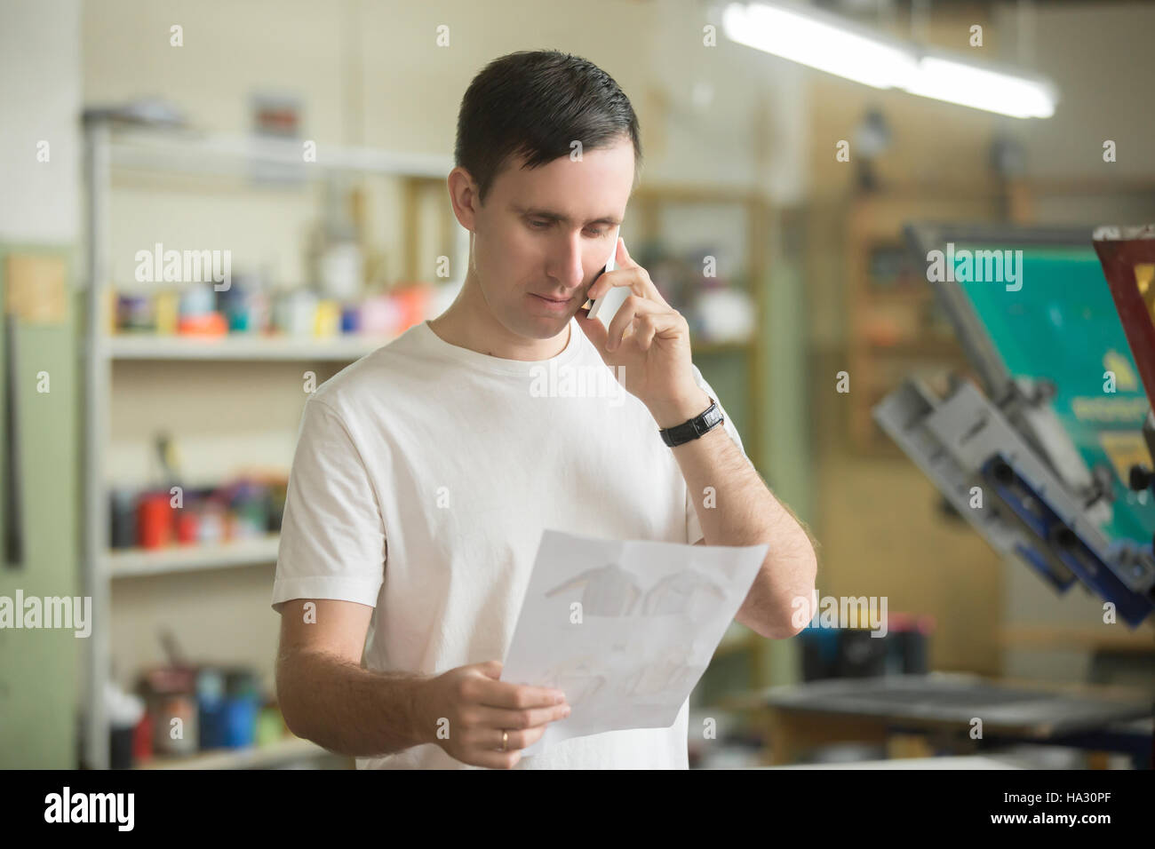 Young worker talking on the phone Stock Photo - Alamy