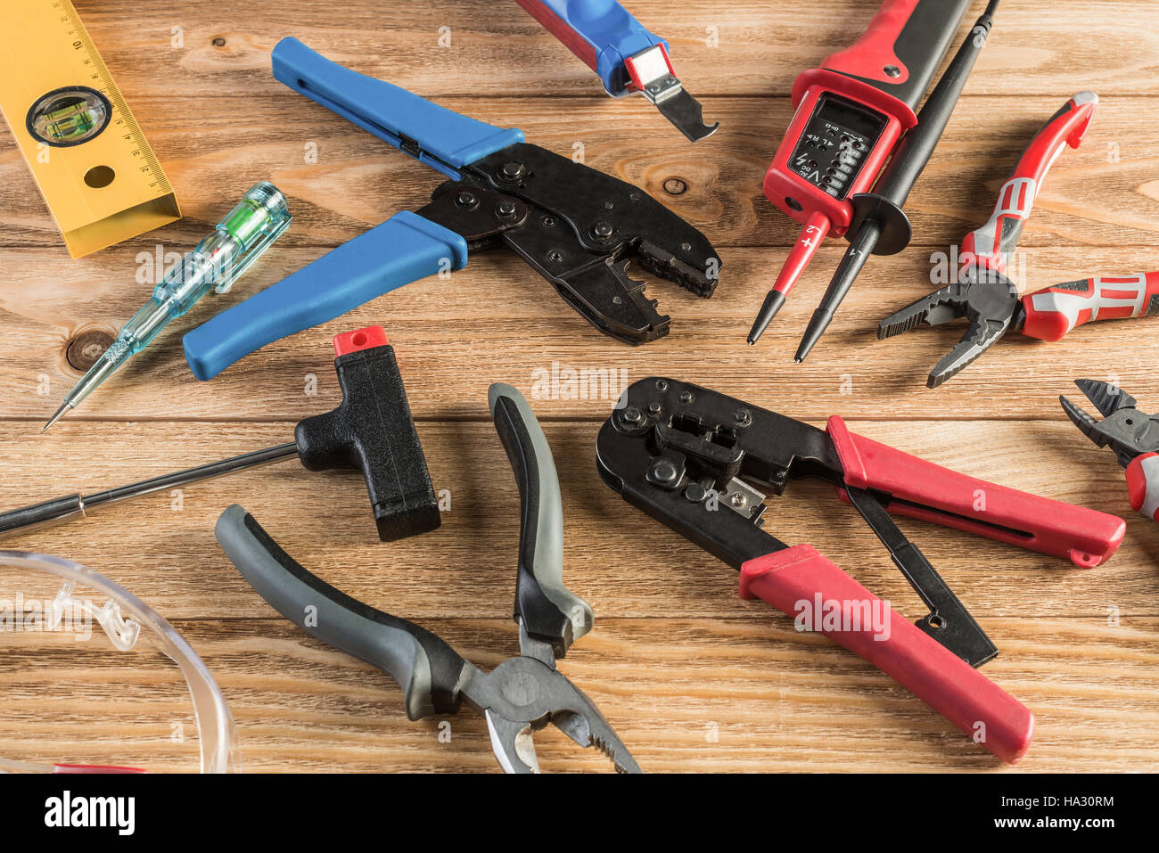 Variety of repair tools on wooden surface Stock Photo - Alamy