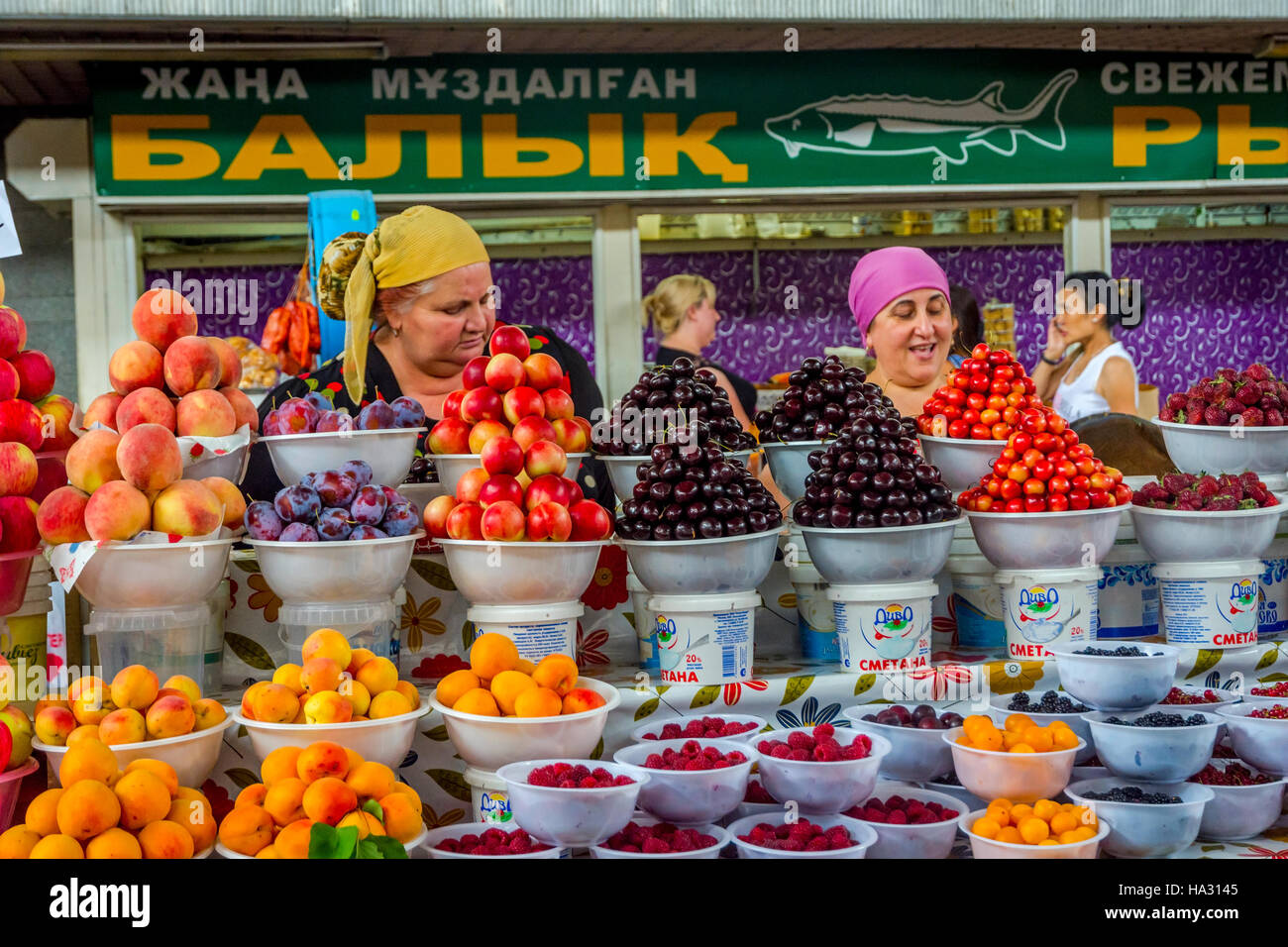 ALMATY, KAZAKHSTAN - JULY 15: Older women selling seasonal fruits at ...