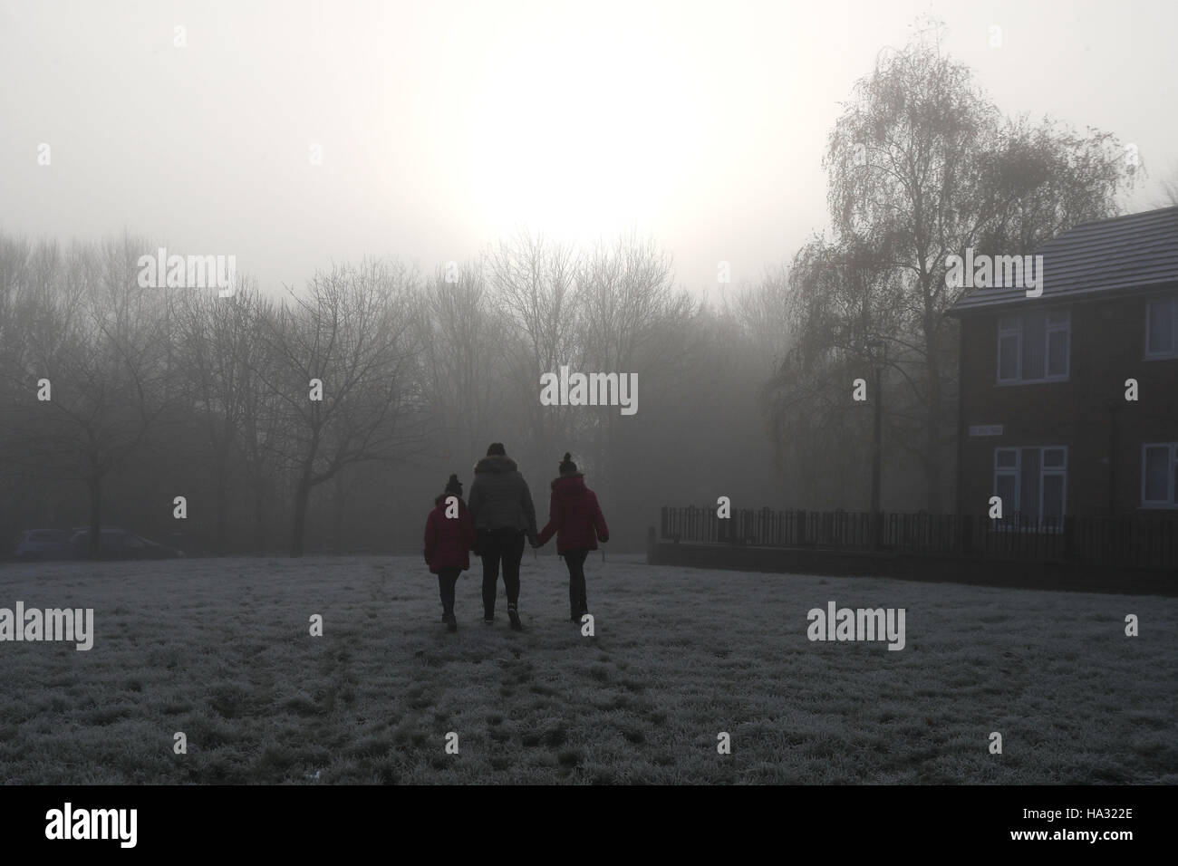 People walk through the mist on the Gateacre estate in Liverpool Stock ...