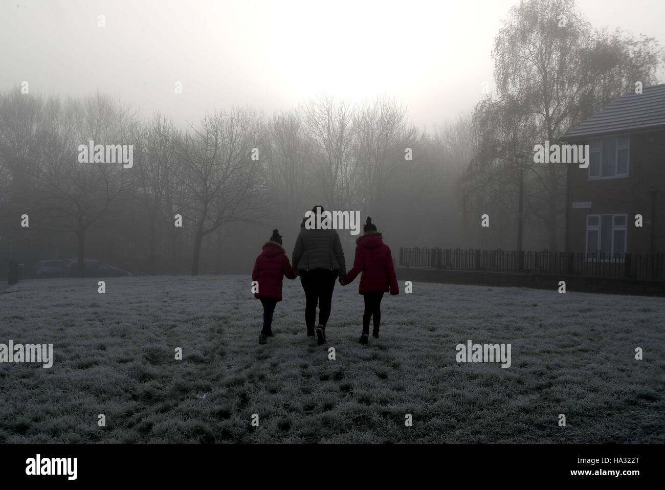 People walk through the mist on the Gateacre estate in Liverpool Stock ...