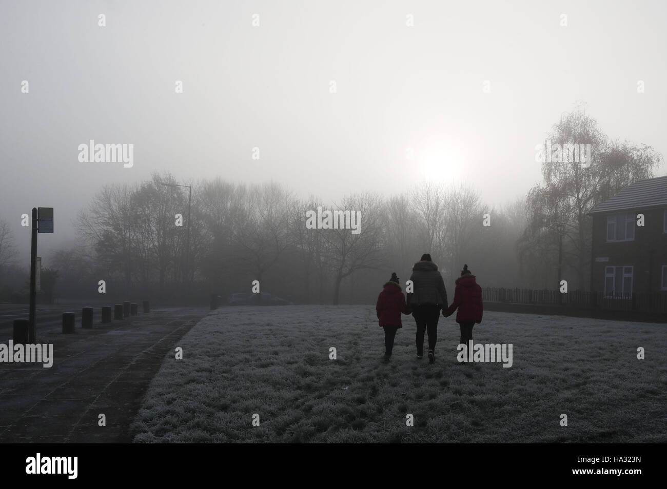 People walk through the mist on the Gateacre estate in Liverpool Stock ...
