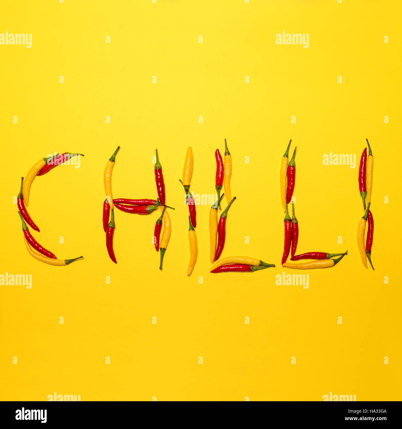 Red hot chili peppers on yellow background making word " CHILLI" - Flat ...