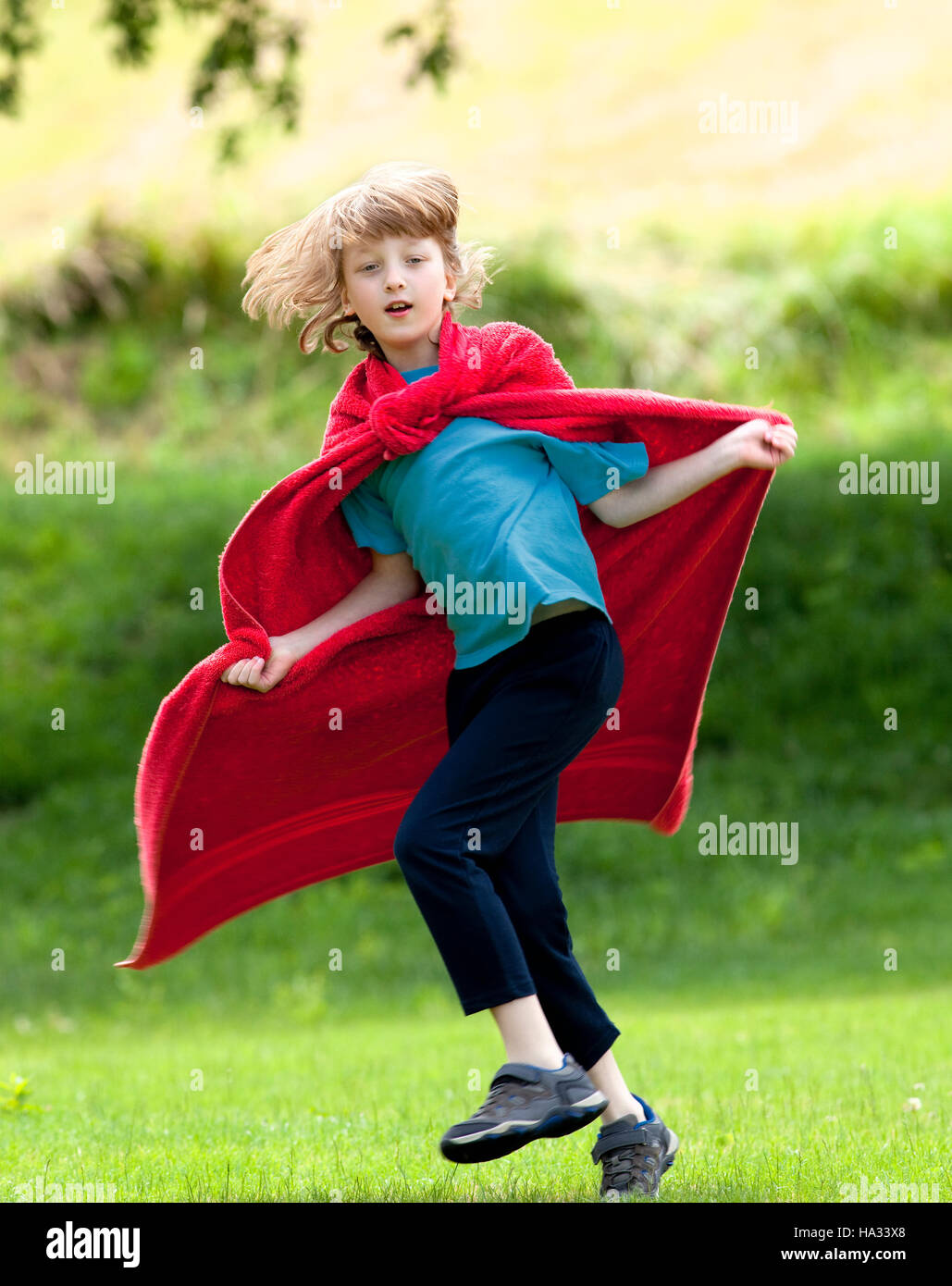 Boy Running Around in Red Towel as Superhero Cloak Stock Photo - Alamy