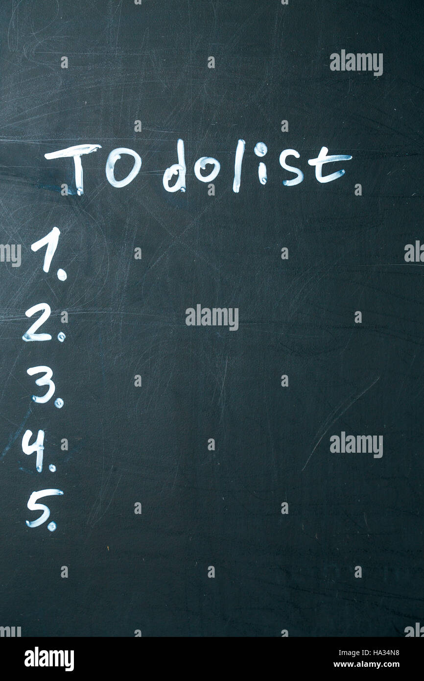 inscription do it list drawn with chalk on a school blackboard dark ...