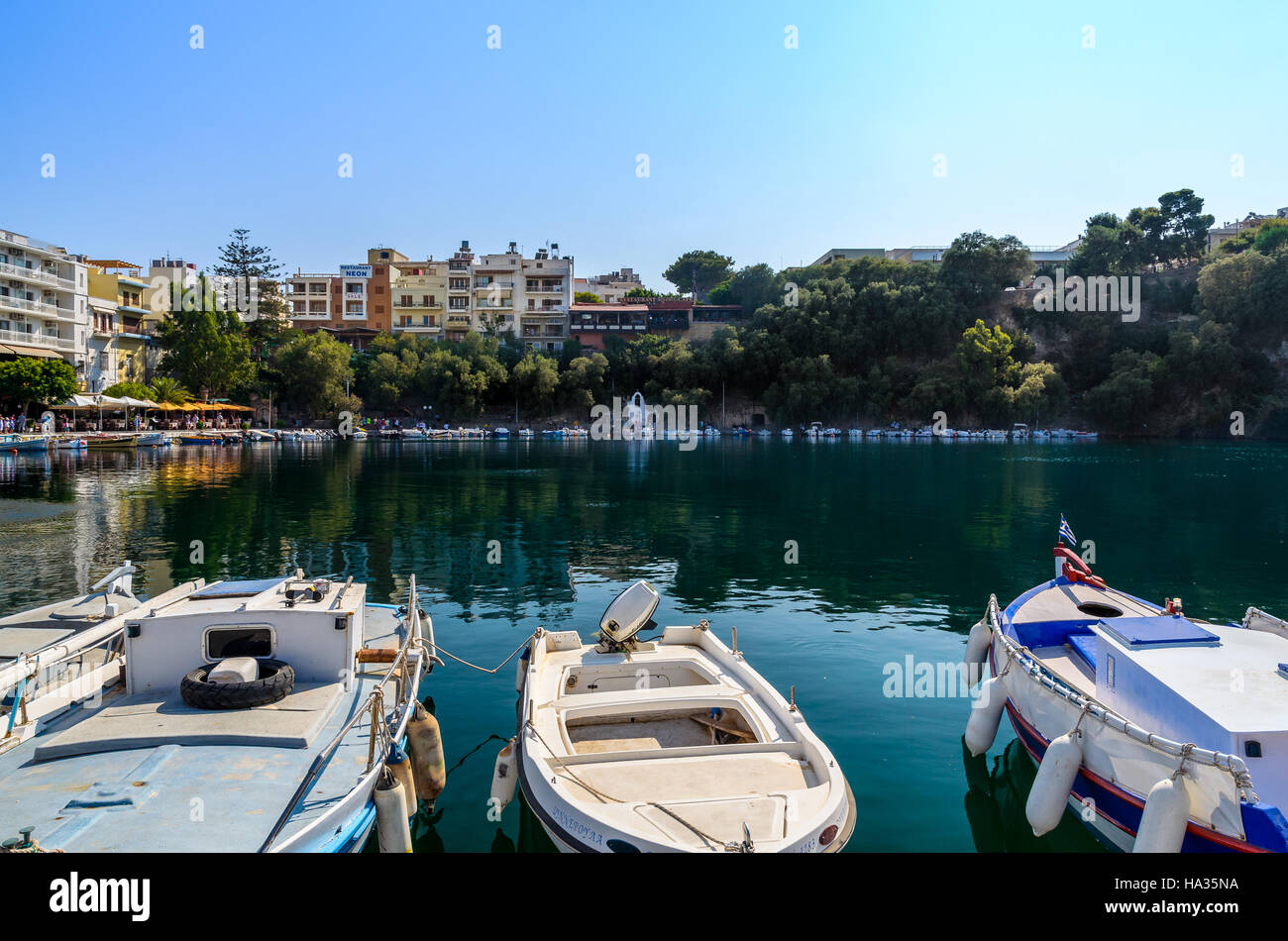 Small harbor with moored fishing boats at Aghios Nikolaos town on Crete ...
