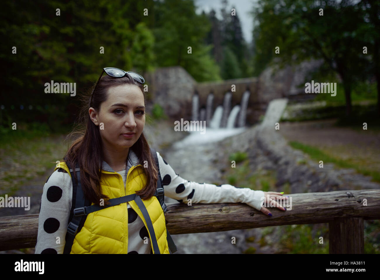 Woman walking over wooden bridge in summer time Stock Photo - Alamy