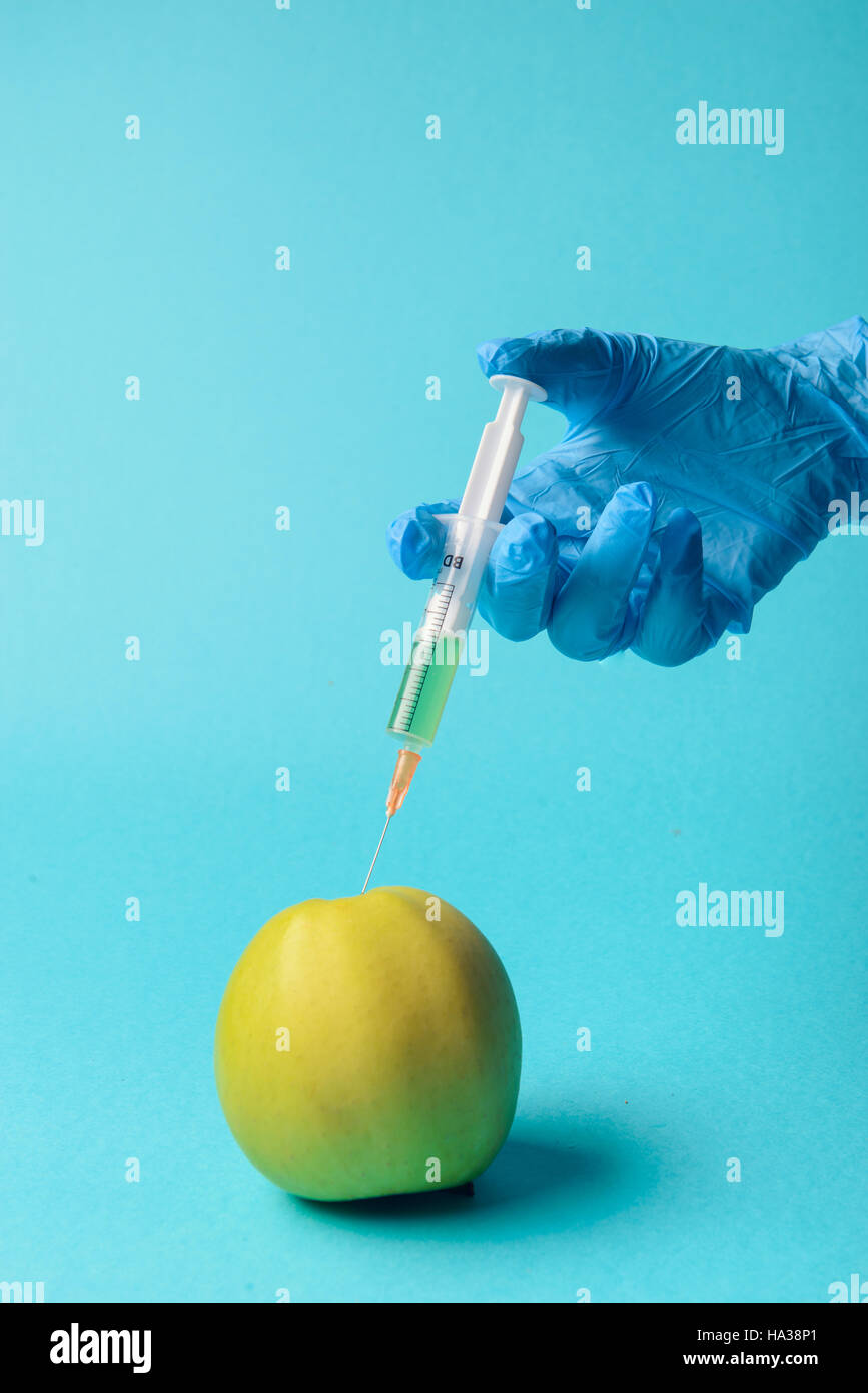 Chemical additives in food or genetically modified fruit concept. Green ...