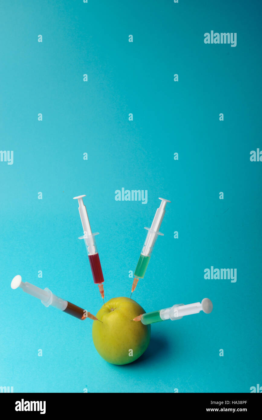 Chemical additives in food or genetically modified fruit concept. Green ...