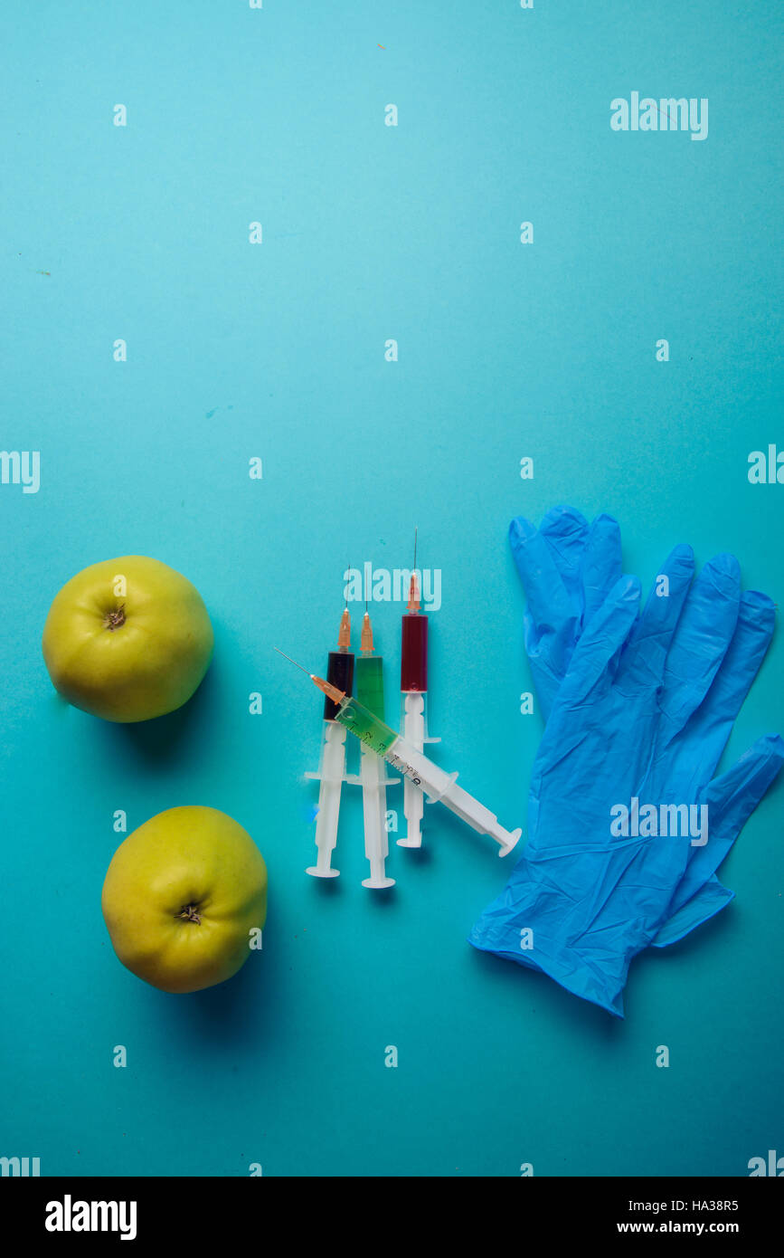 Chemical additives in food or genetically modified fruit concept. Green ...