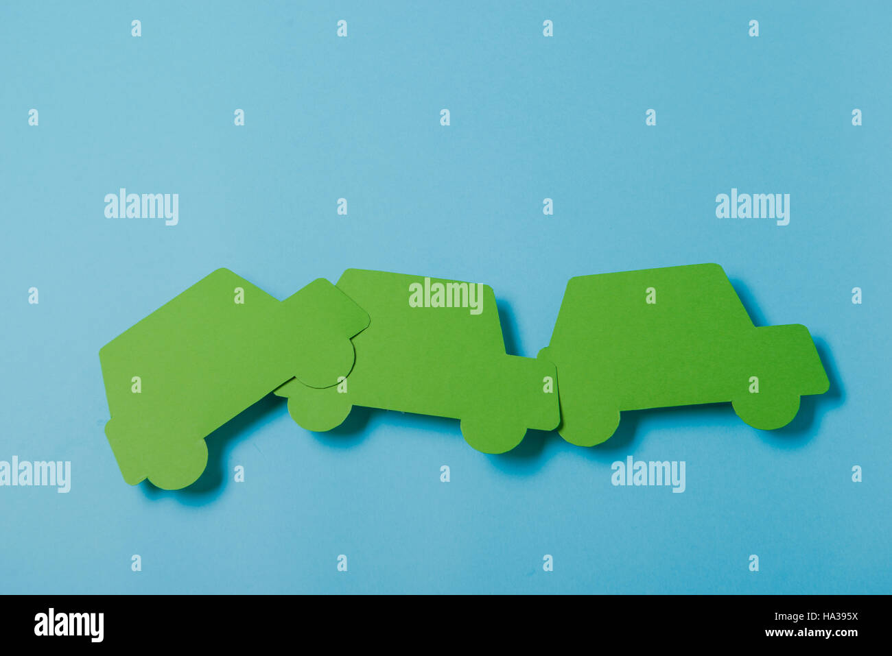 paper green cars figure. top view on blue background Stock Photo - Alamy