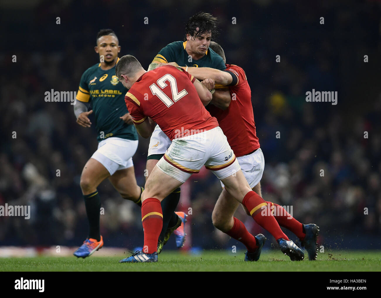 South Africa's Lood de Jager (centre) is tackled by Wales' Scott ...