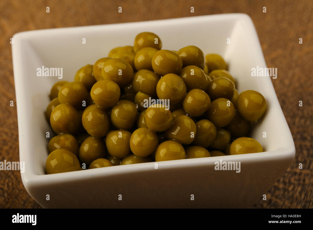 Pickled green pea on the wood background Stock Photo - Alamy