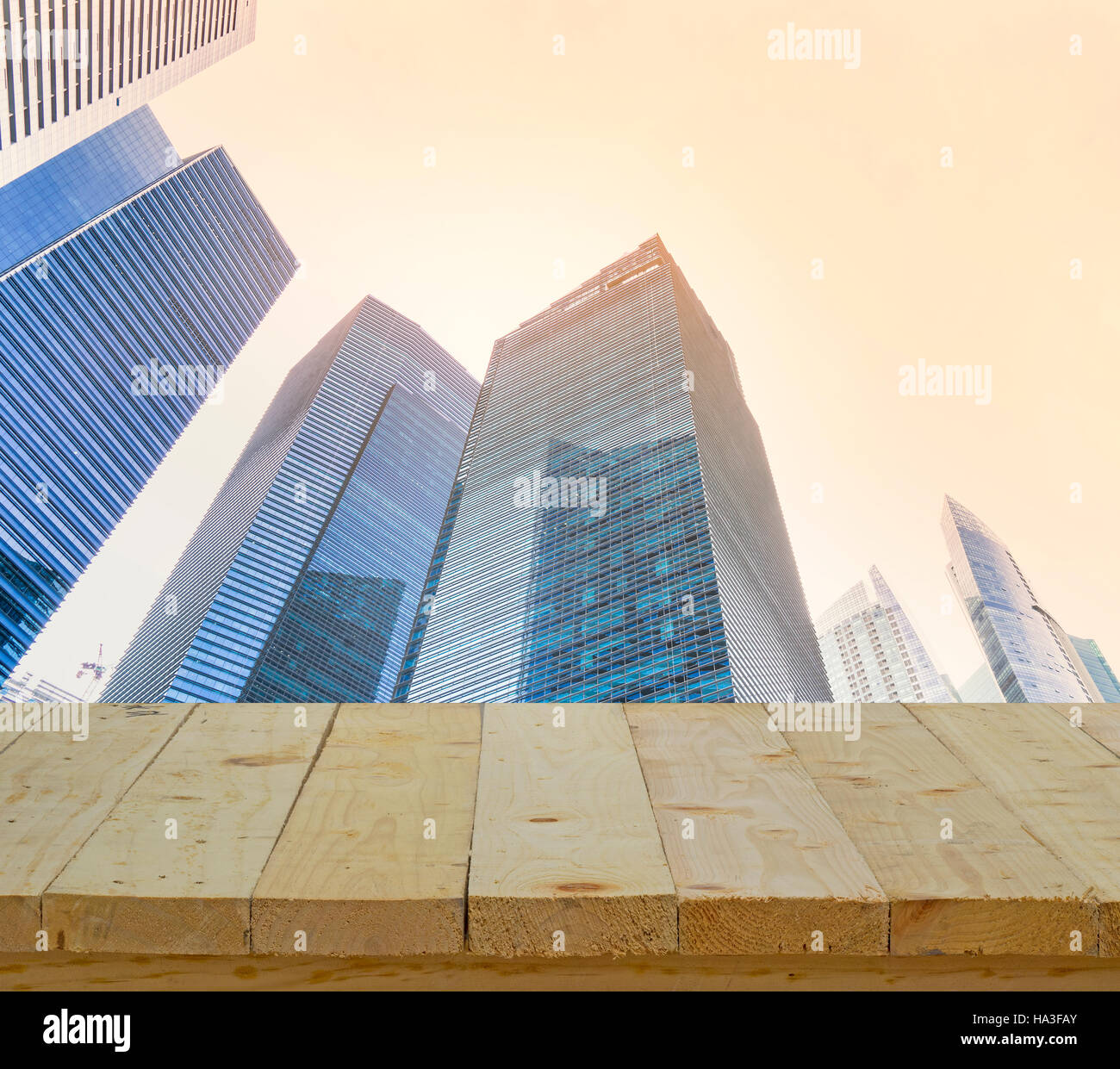 wood table top on abstract building perspective with sun light filter ...