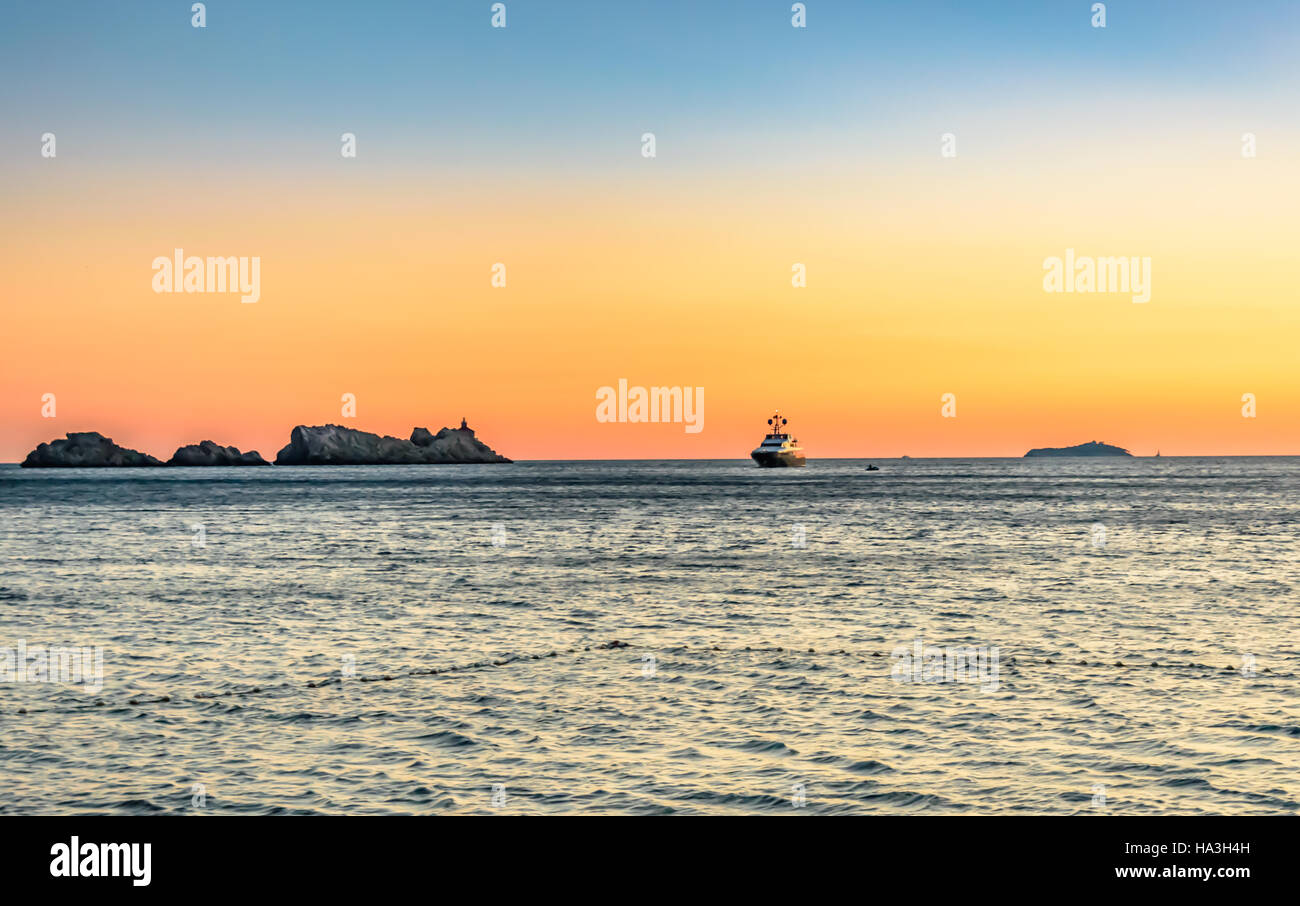 Ship sailing at sunset Stock Photo - Alamy