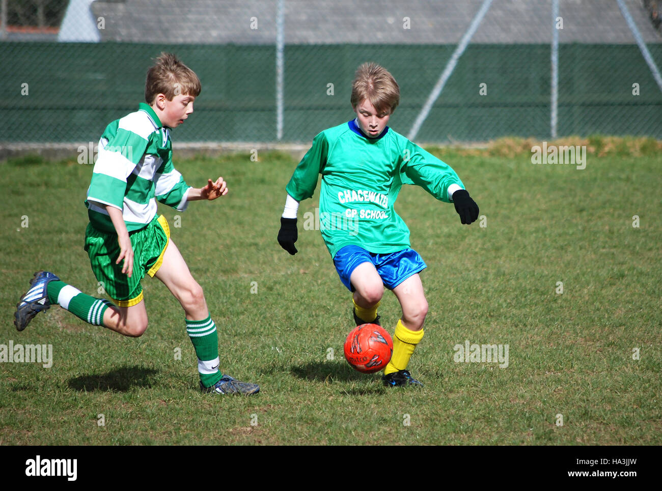 young boys playing football Stock Photo - Alamy