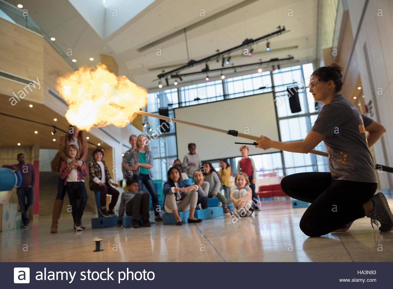Children watching scientist conducting fire demonstration in science ...