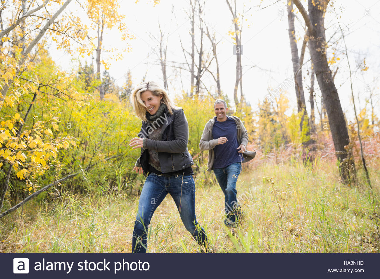 Two people running in woods hi-res stock photography and images - Alamy