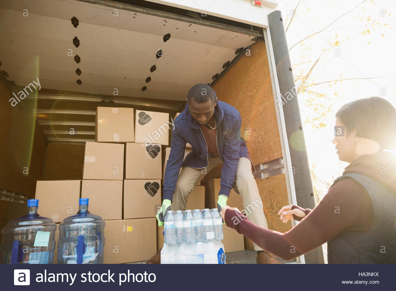 Woman lifting water bottles hi-res stock photography and images - Alamy