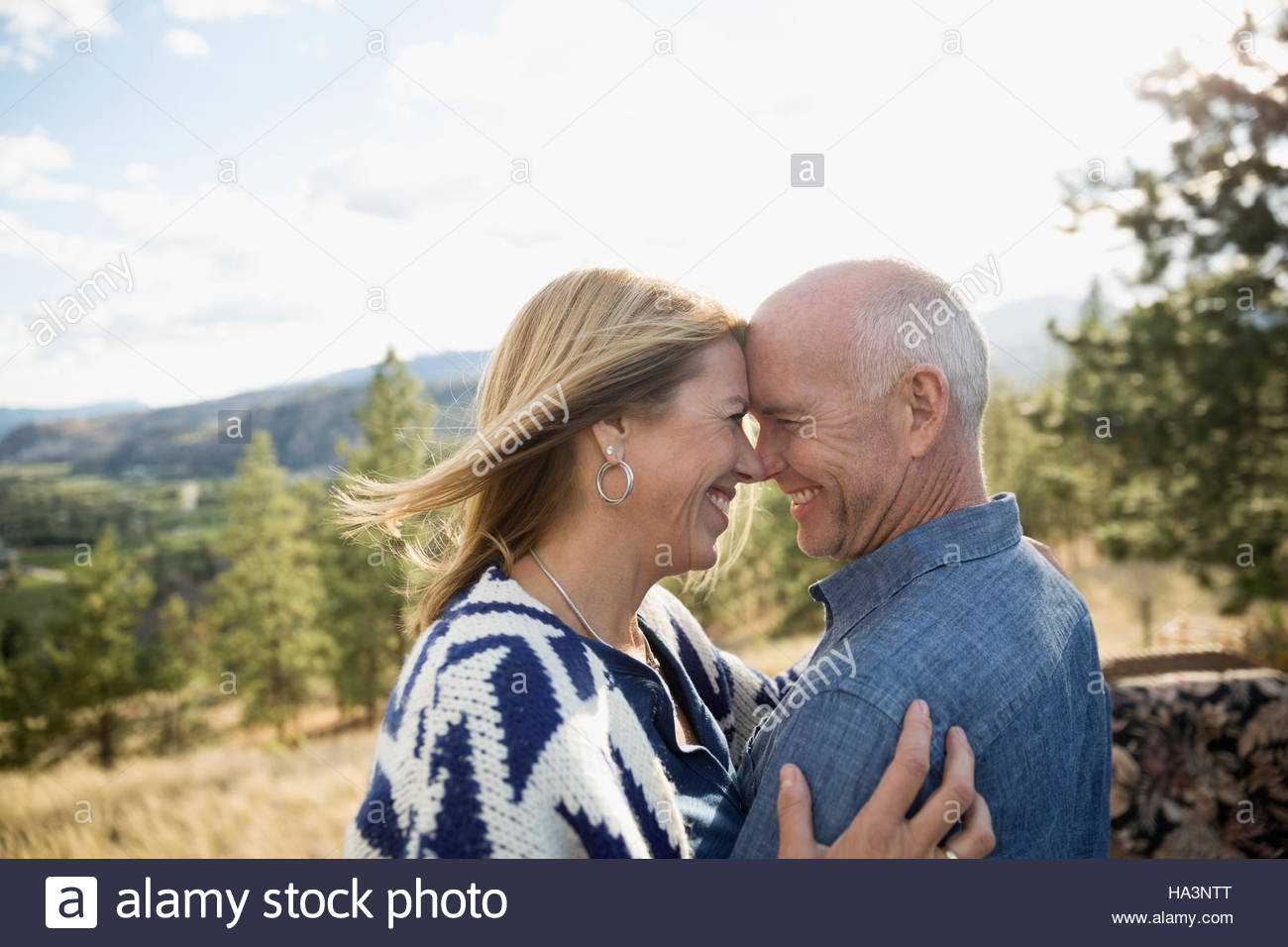 Affectionate couple face to face in woods Stock Photo - Alamy