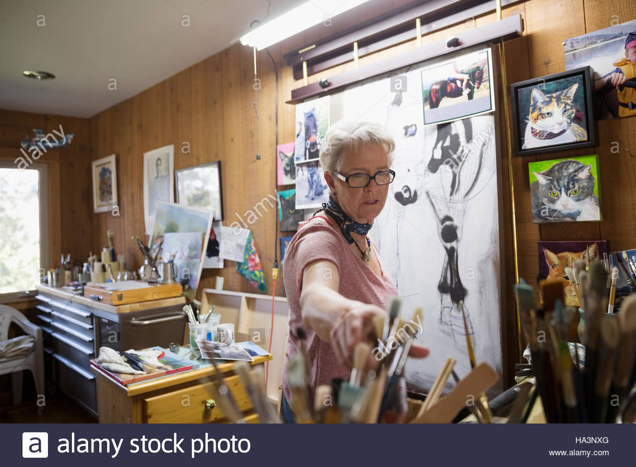 Senior woman artist painting in art studio Stock Photo - Alamy