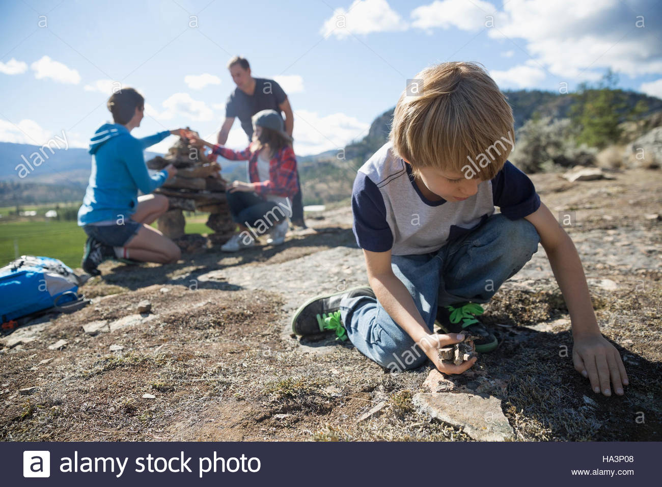 Family gathering and stacking rocks Stock Photo - Alamy