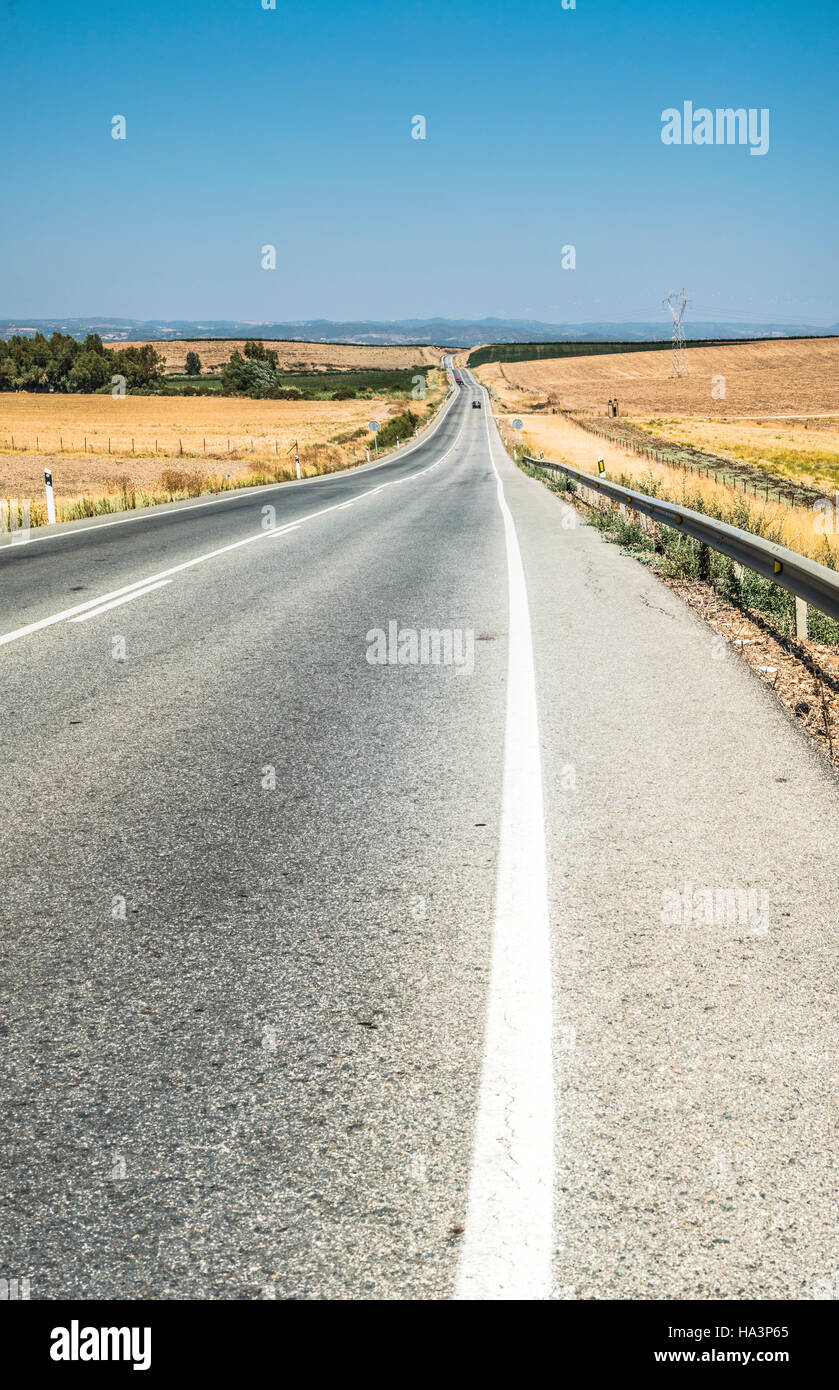 Long asphalt road and blue sky Stock Photo - Alamy