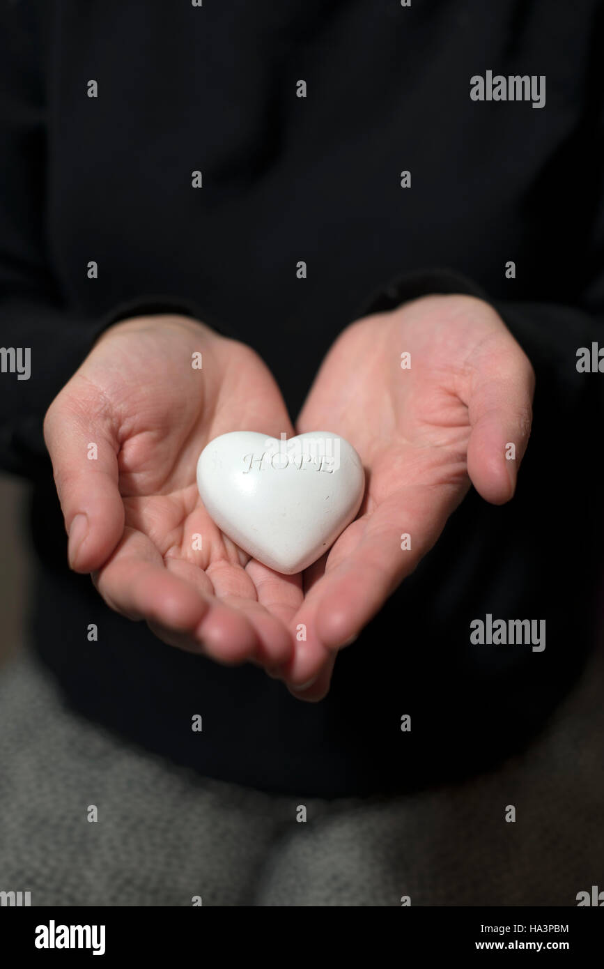 Woman hold in hands heart. Help concept and expectation Stock Photo - Alamy