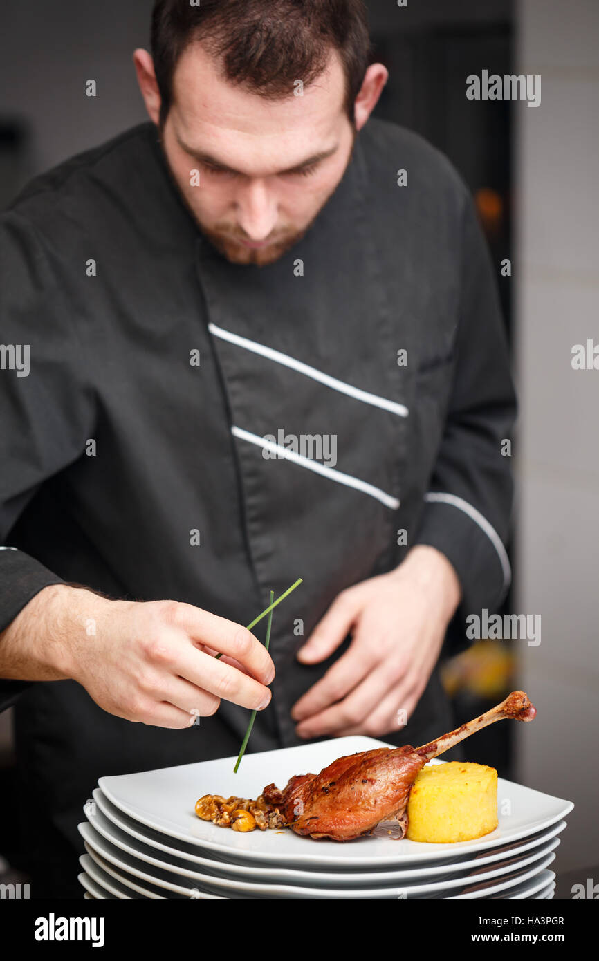 Chef is making meat dish on commercial kitchen Stock Photo - Alamy