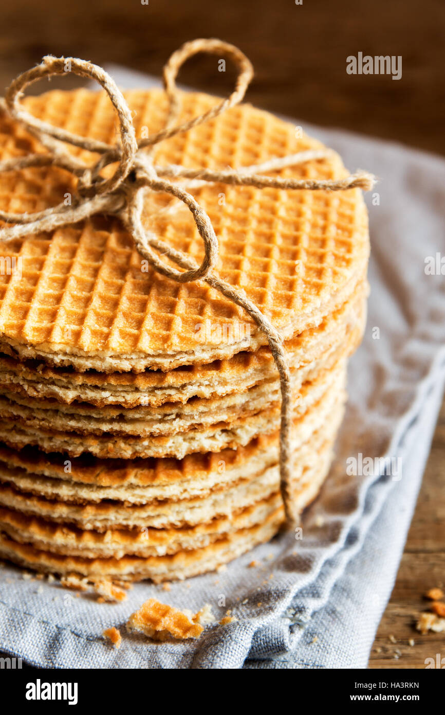 Stack of traditional dutch caramel waffles tied up with jute twine on ...