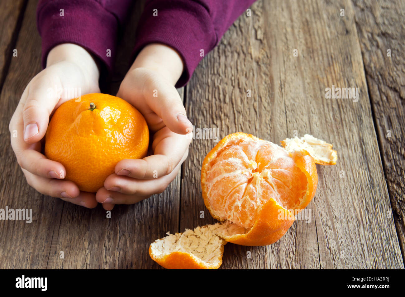 Child peeling orange hi-res stock photography and images - Alamy