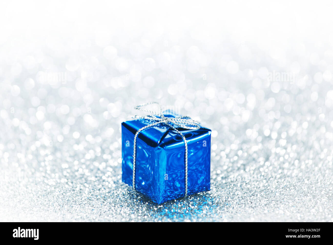 Beautiful small blue holiday gift box on silver glitters Stock Photo ...
