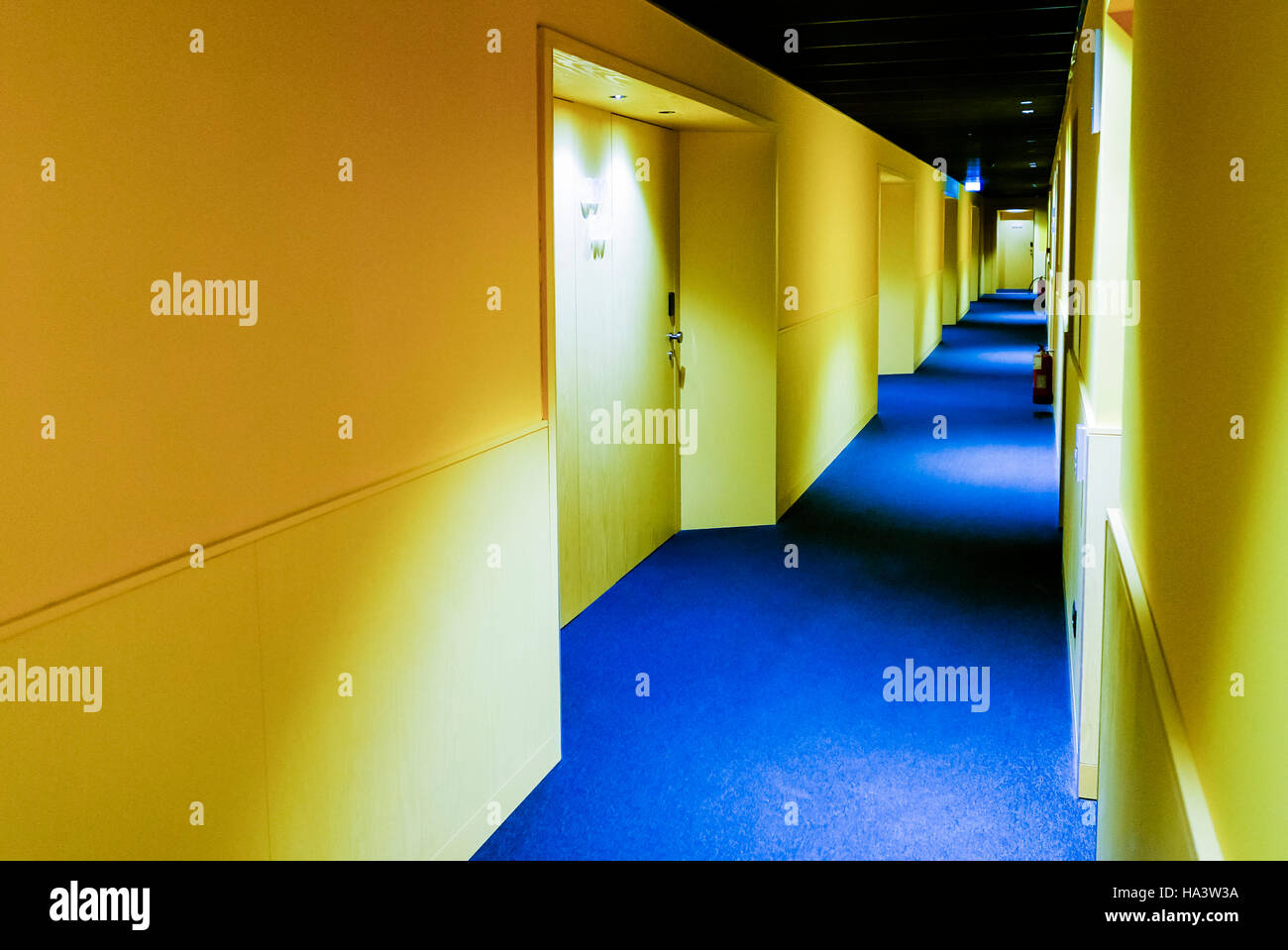 Bright yellow corridor in a hotel Stock Photo - Alamy