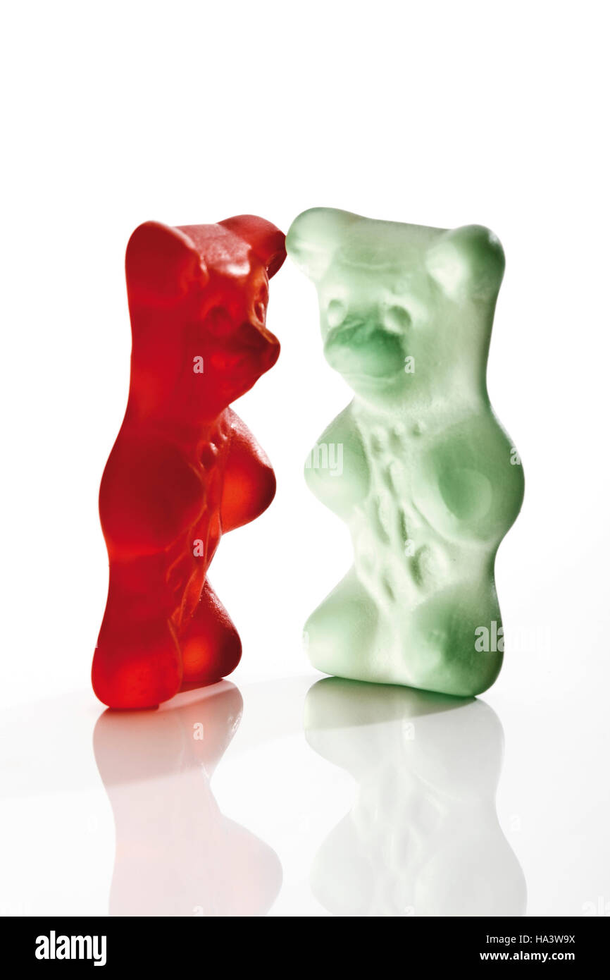 Two multicoloured gummi bears opposite of each other Stock Photo - Alamy