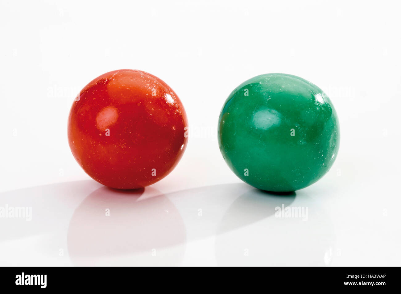 A red and a green gumball Stock Photo - Alamy
