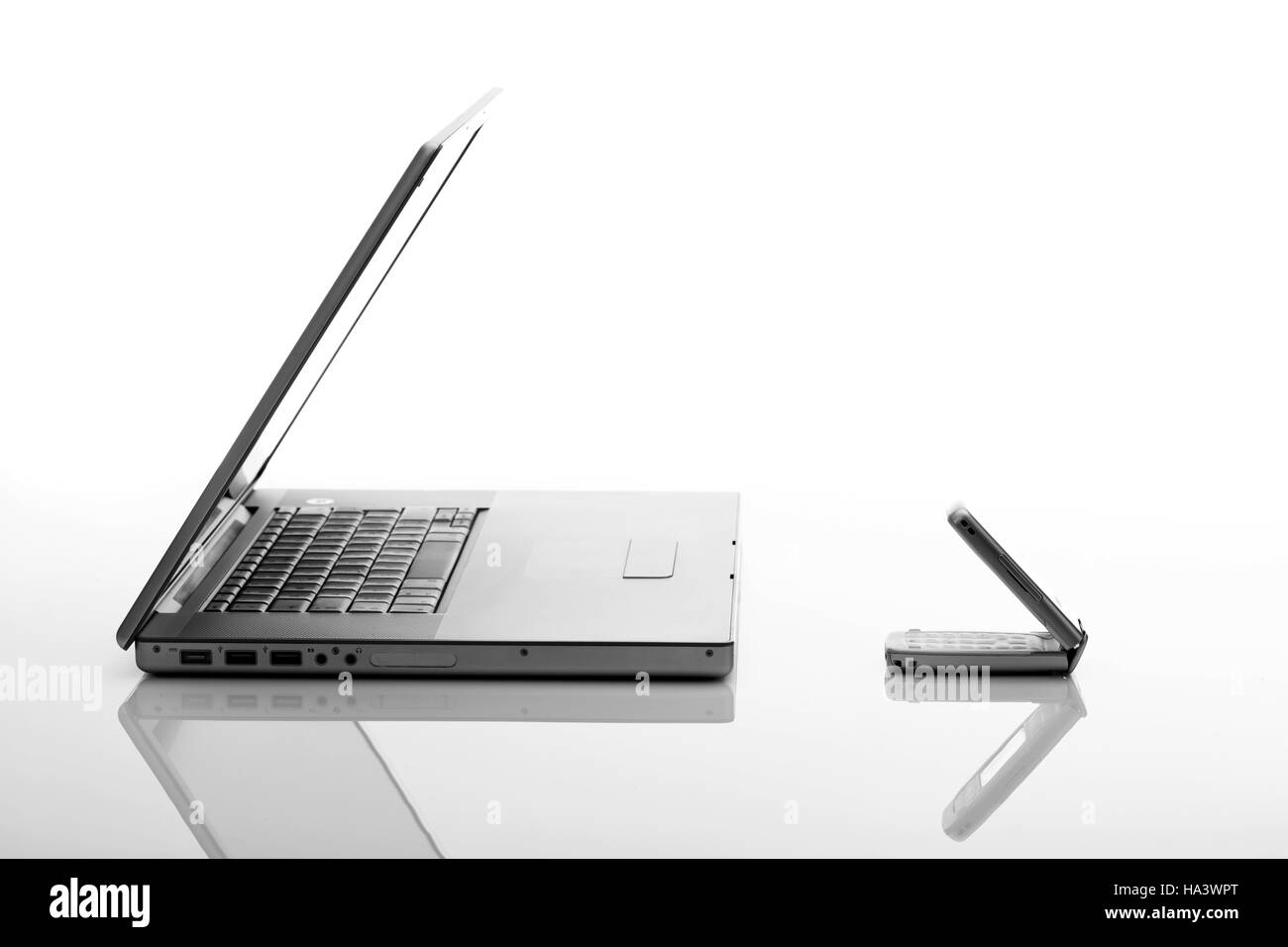 Laptop and mobilephone opposite each other, opened Stock Photo - Alamy