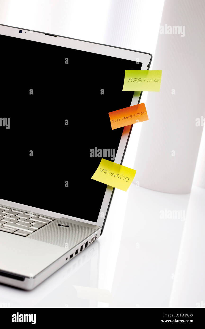 Colourful notepads on laptop Stock Photo - Alamy
