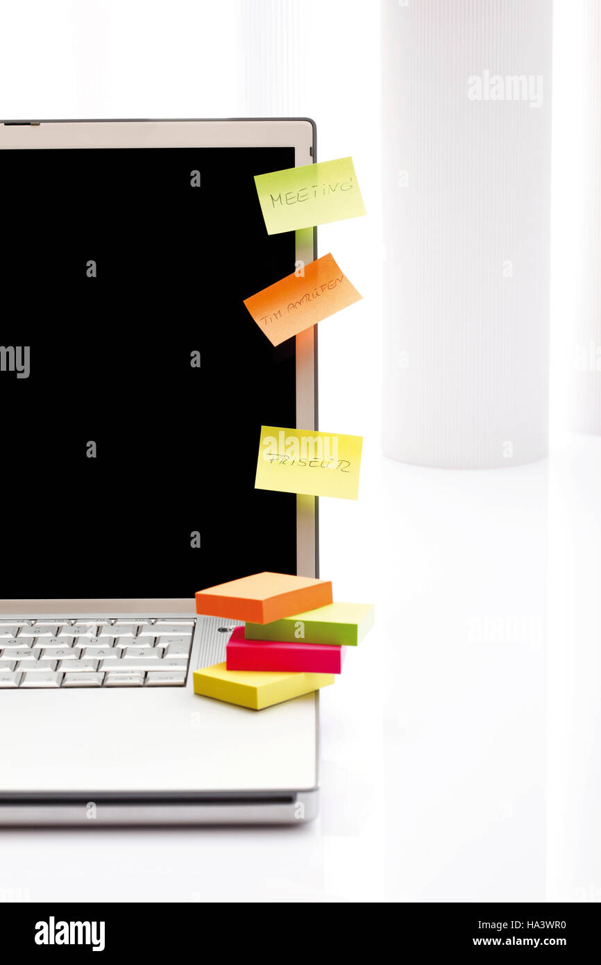 Colourful notepads on laptop Stock Photo - Alamy