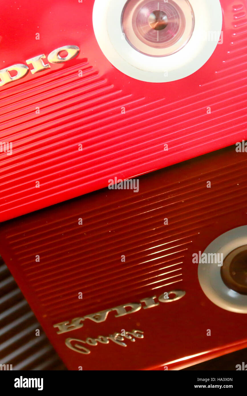 A red vintage analogue style radio, which is in fact a biscuit tin ...