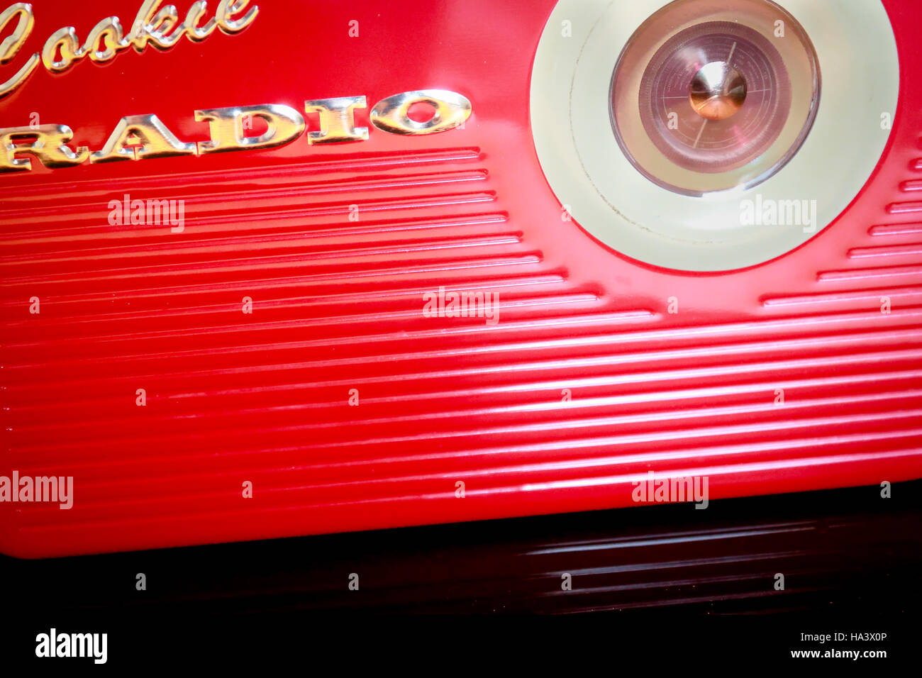 A red vintage analogue style radio, which is in fact a biscuit tin ...
