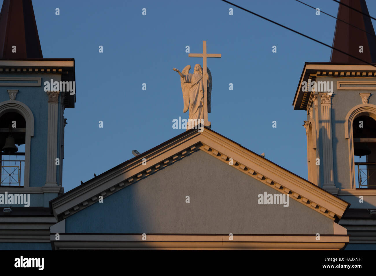 roof of a blue catholic church with angel statue Stock Photo - Alamy