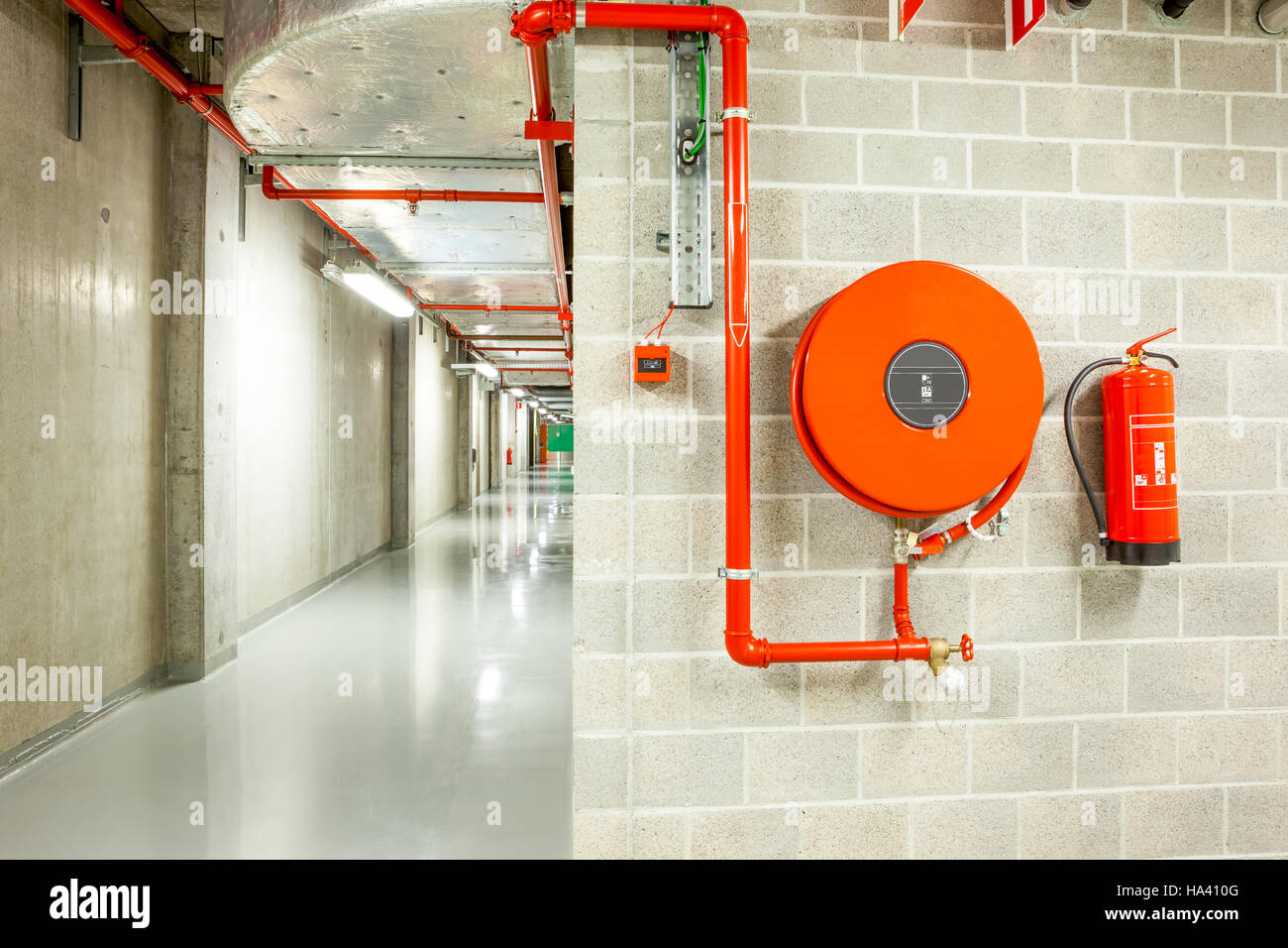 an fire hose hanging on the wall in an staircase Stock Photo - Alamy