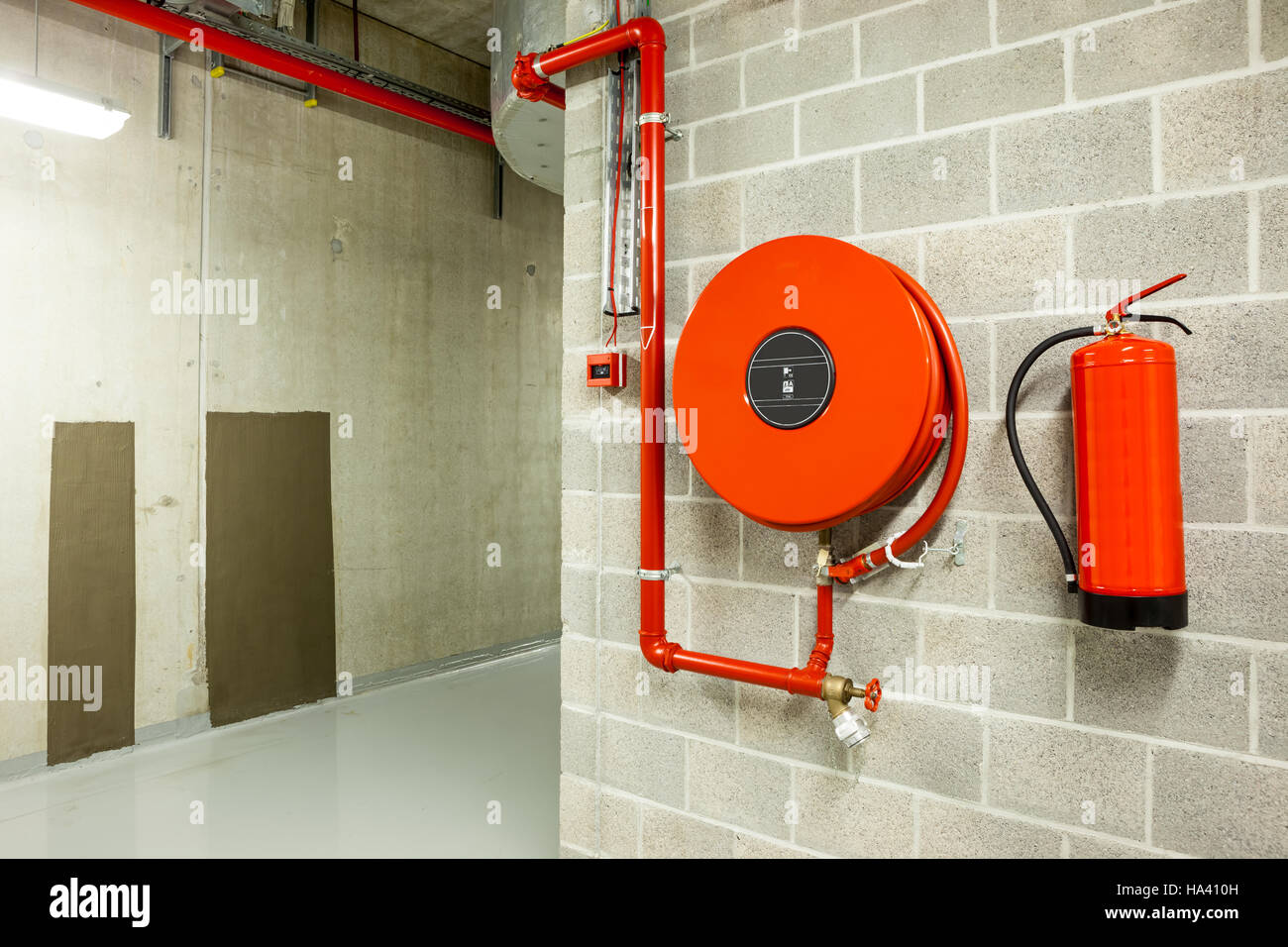 an fire hose hanging on the wall in an staircase Stock Photo - Alamy