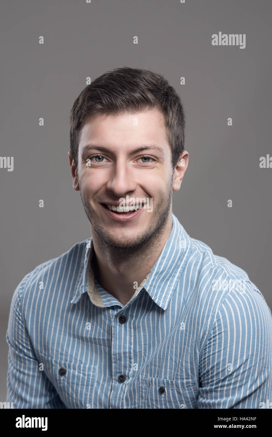 Vertical portrait of young smiling successful business man looking at ...