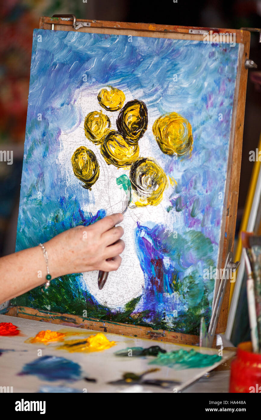 Process of oil painting, artist paints picture on canvas. Sunflowers ...