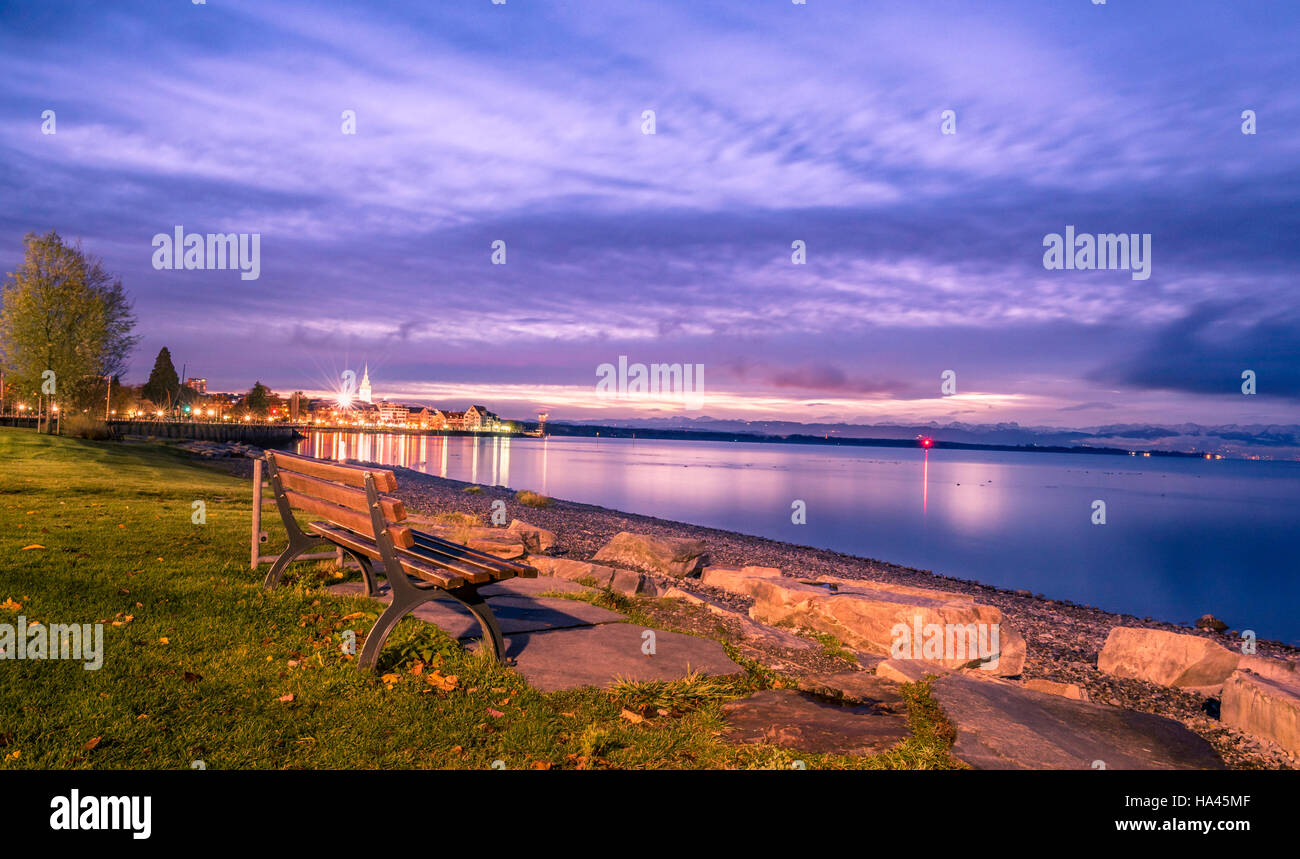 Colorful view over the Bodensee lake as the sun starts rising, with a ...