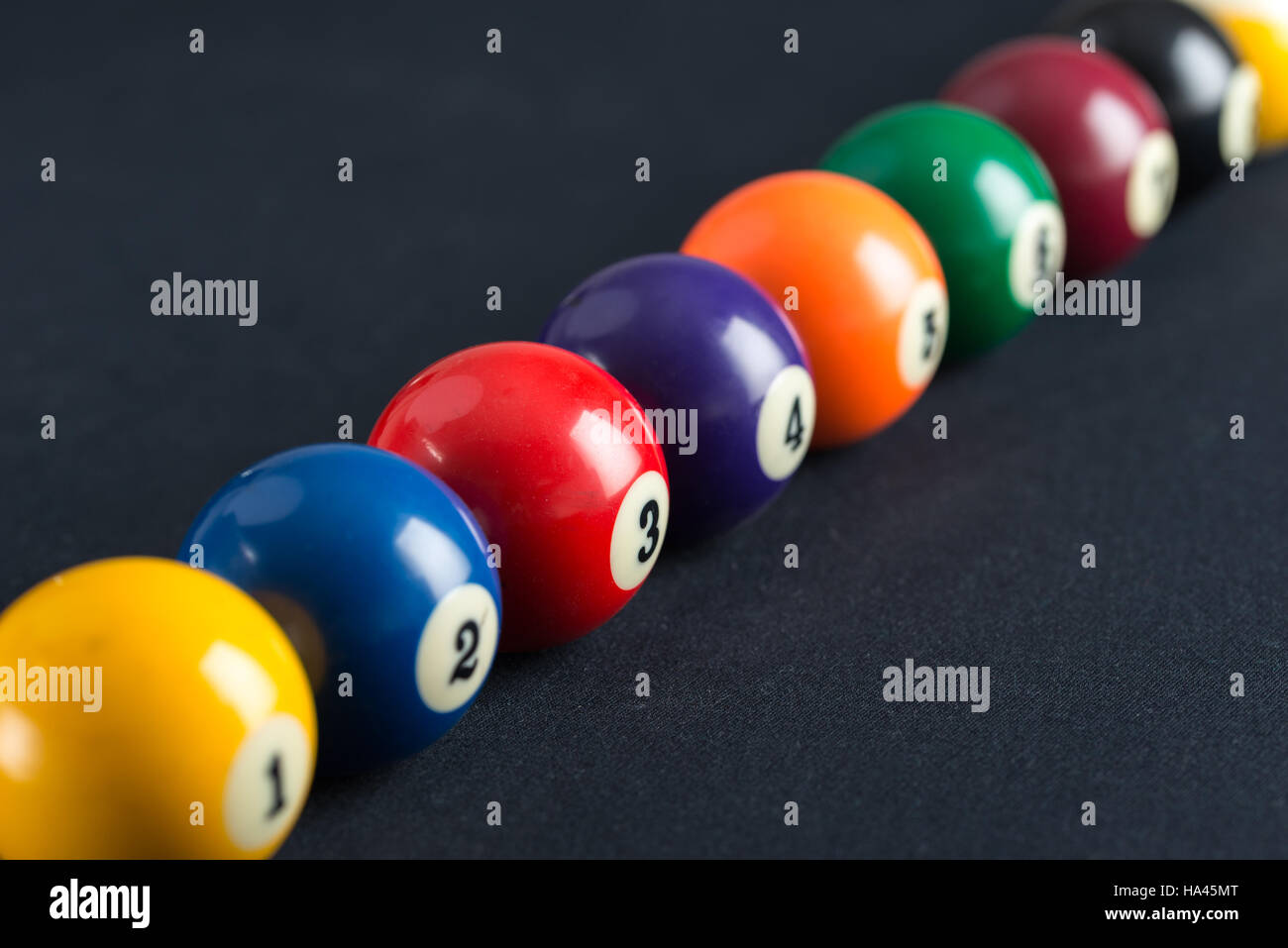 Billiard balls in a row on blue table Stock Photo - Alamy