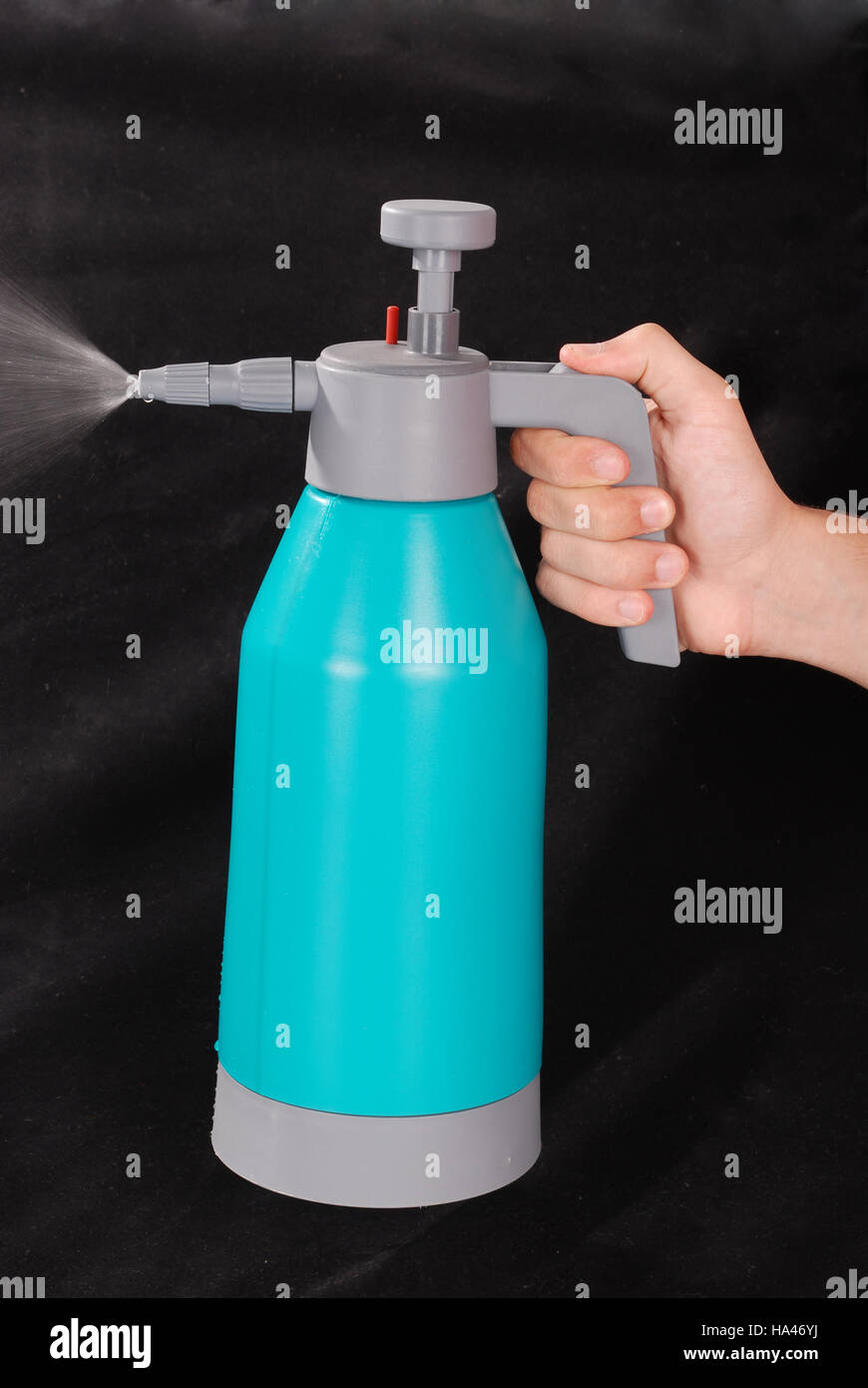 Male hand holding spray bottle isolated on black background Stock Photo ...