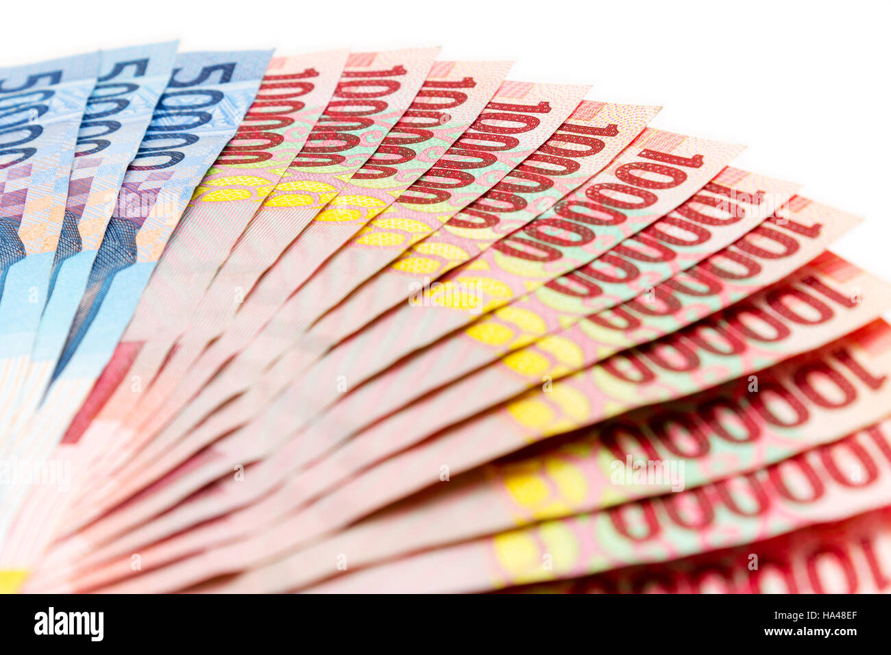 Piles of Indonesian Rupiah (IDR) banknotes on the white background ...