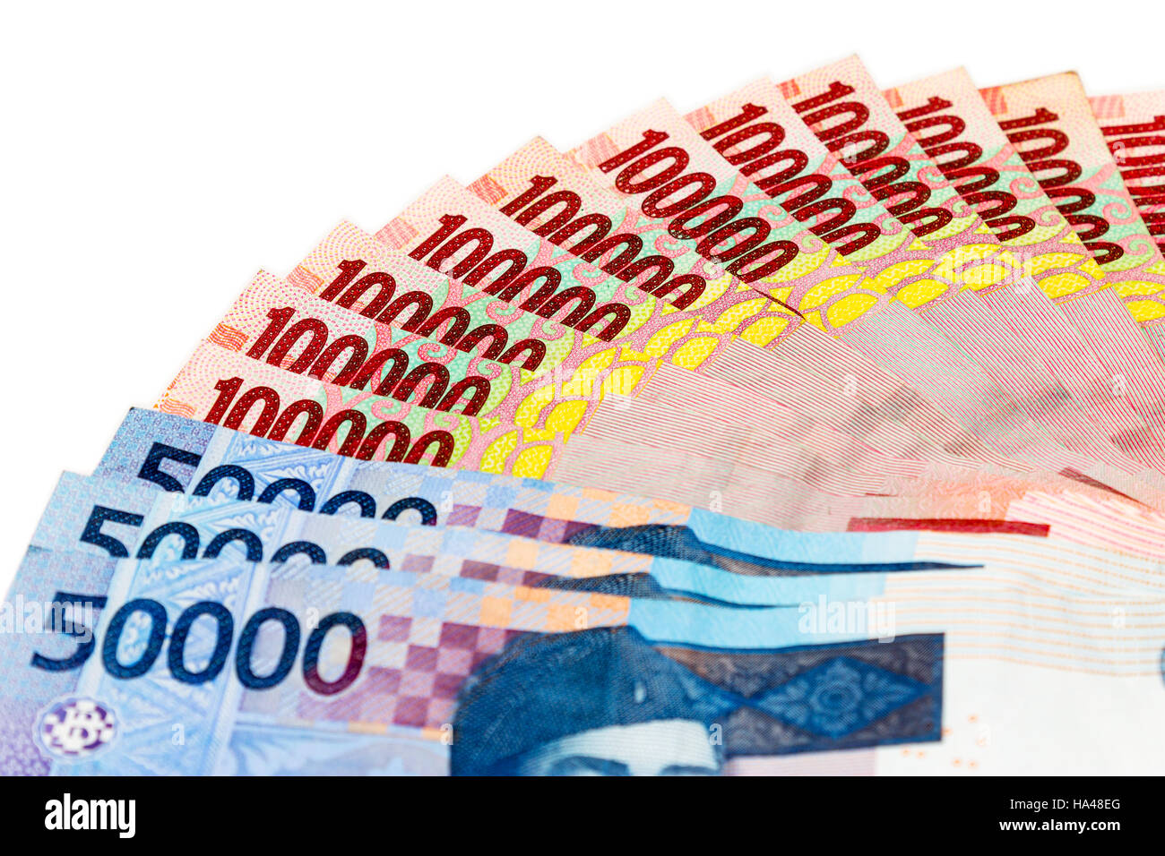 Piles of Indonesian Rupiah (IDR) banknotes on the white background ...
